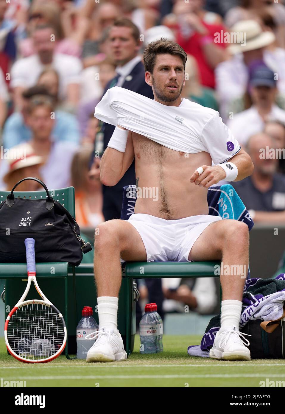 Cameron Norrie changes his shirt during his Gentlemen's Singles quarter ...