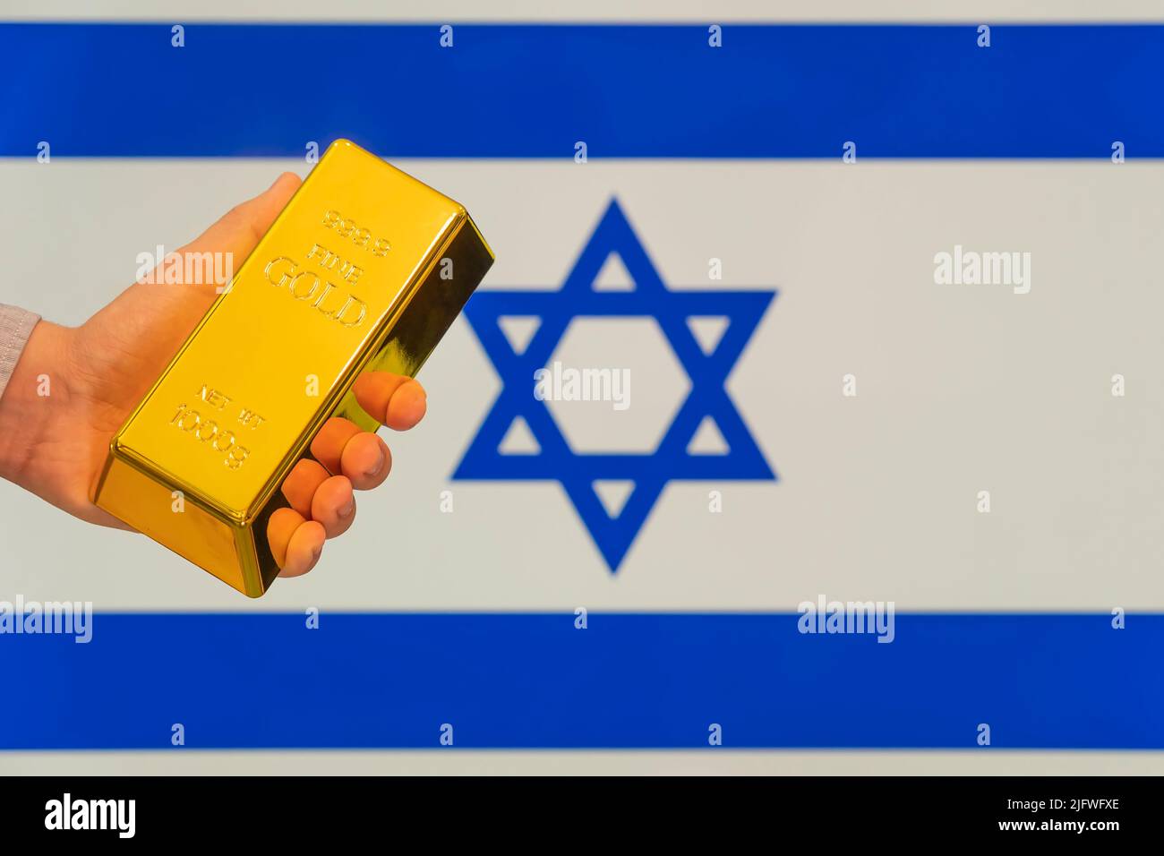 golden bullion in a man's hand on the israeli flag background Stock ...