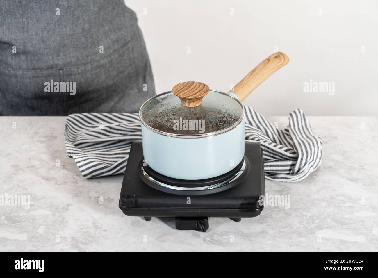 Flat lay. Cooking boba pearls in a cooking pot to prepare mango boba ...