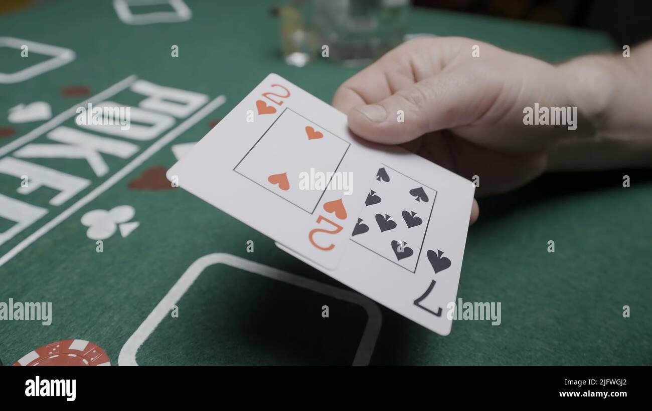 Poker players at a green table with chips and cards. Action. Concept of ...
