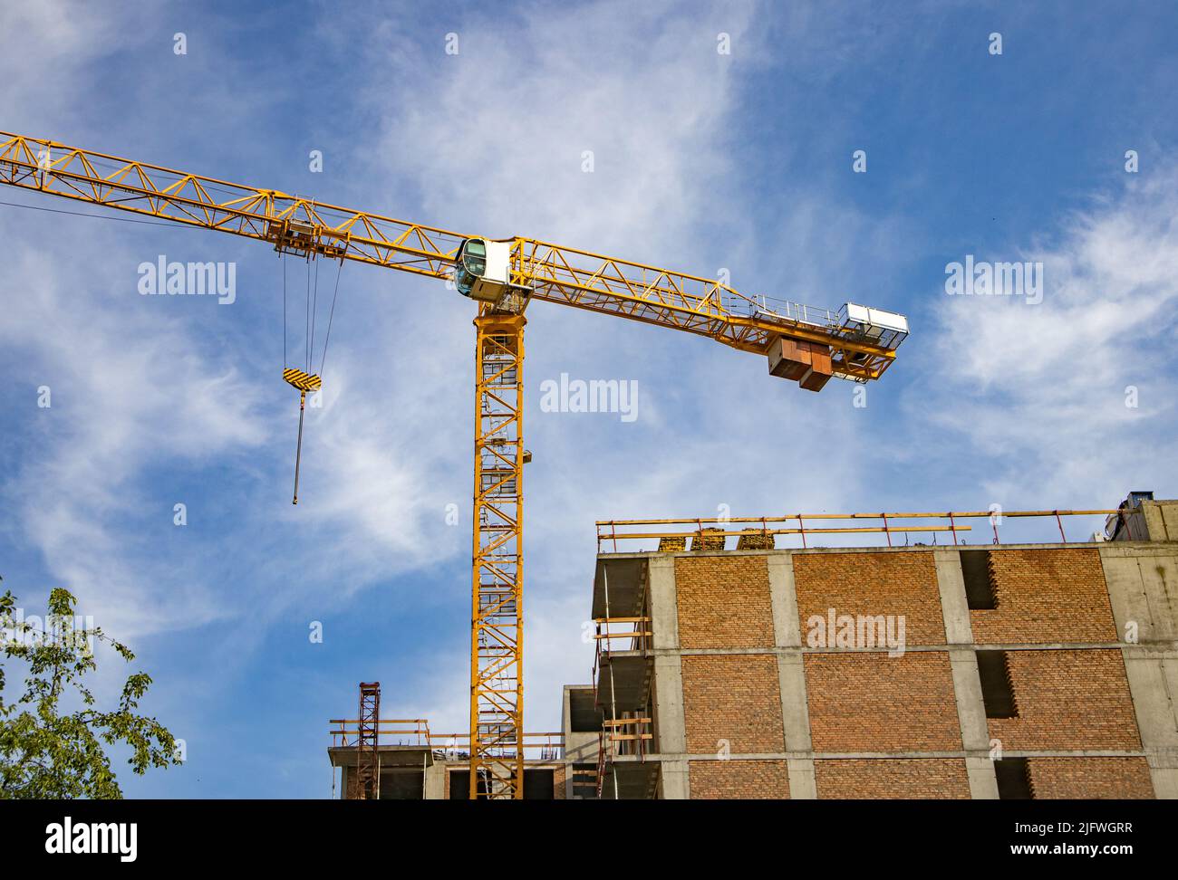 Construction tower crane on the construction site of a modern brick ...