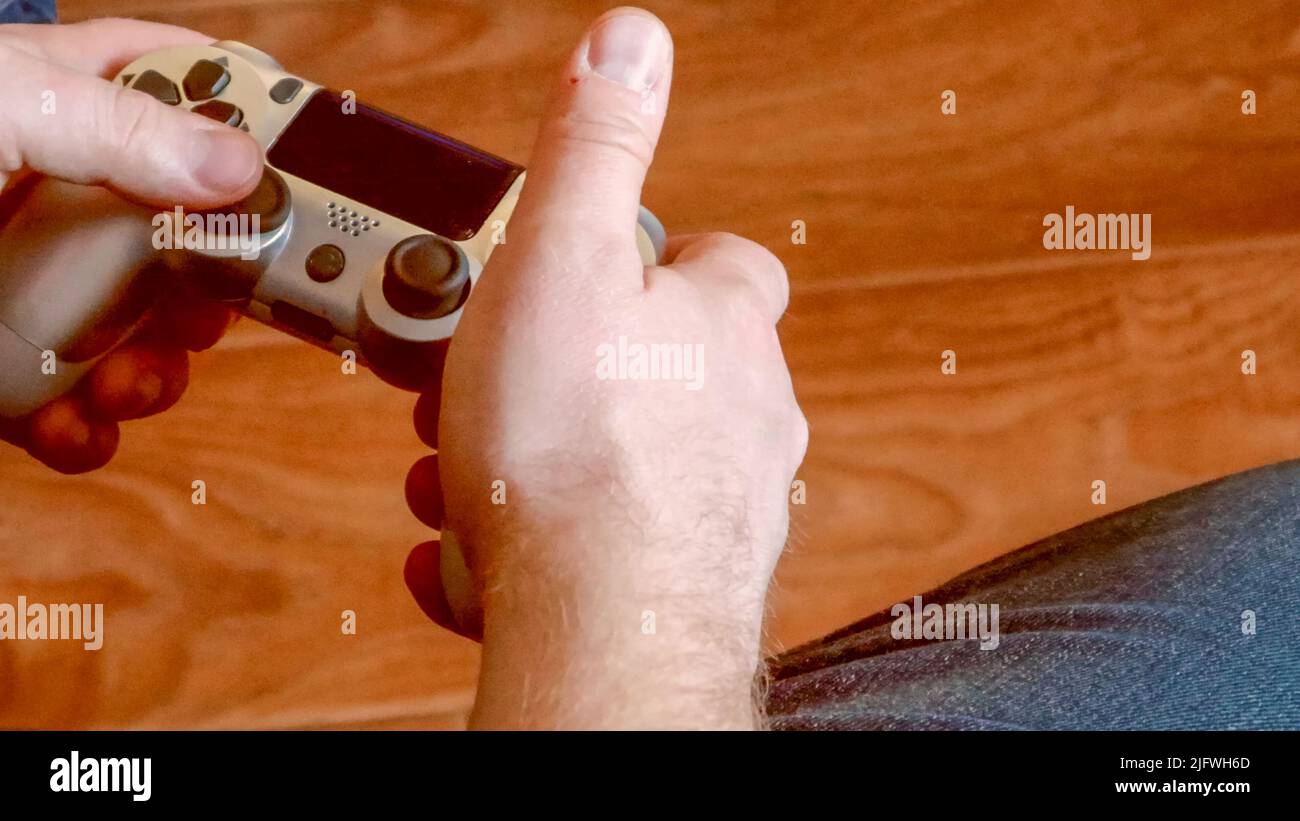 using a controller to play video games - a close-up of hands and a ...