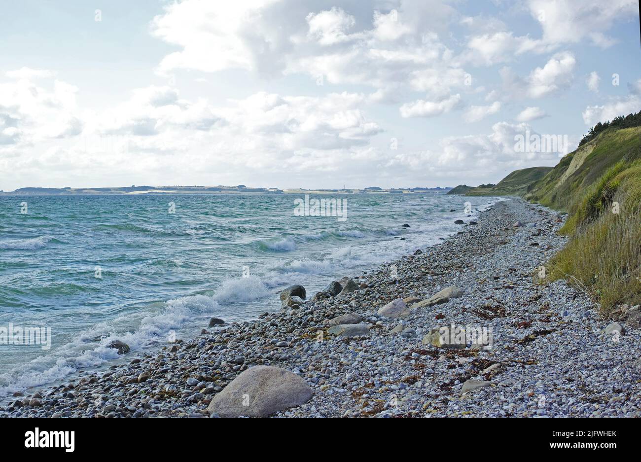 Coast of Kattegat - Helgenaes, Denmark. Ocean waves washing onto empty ...