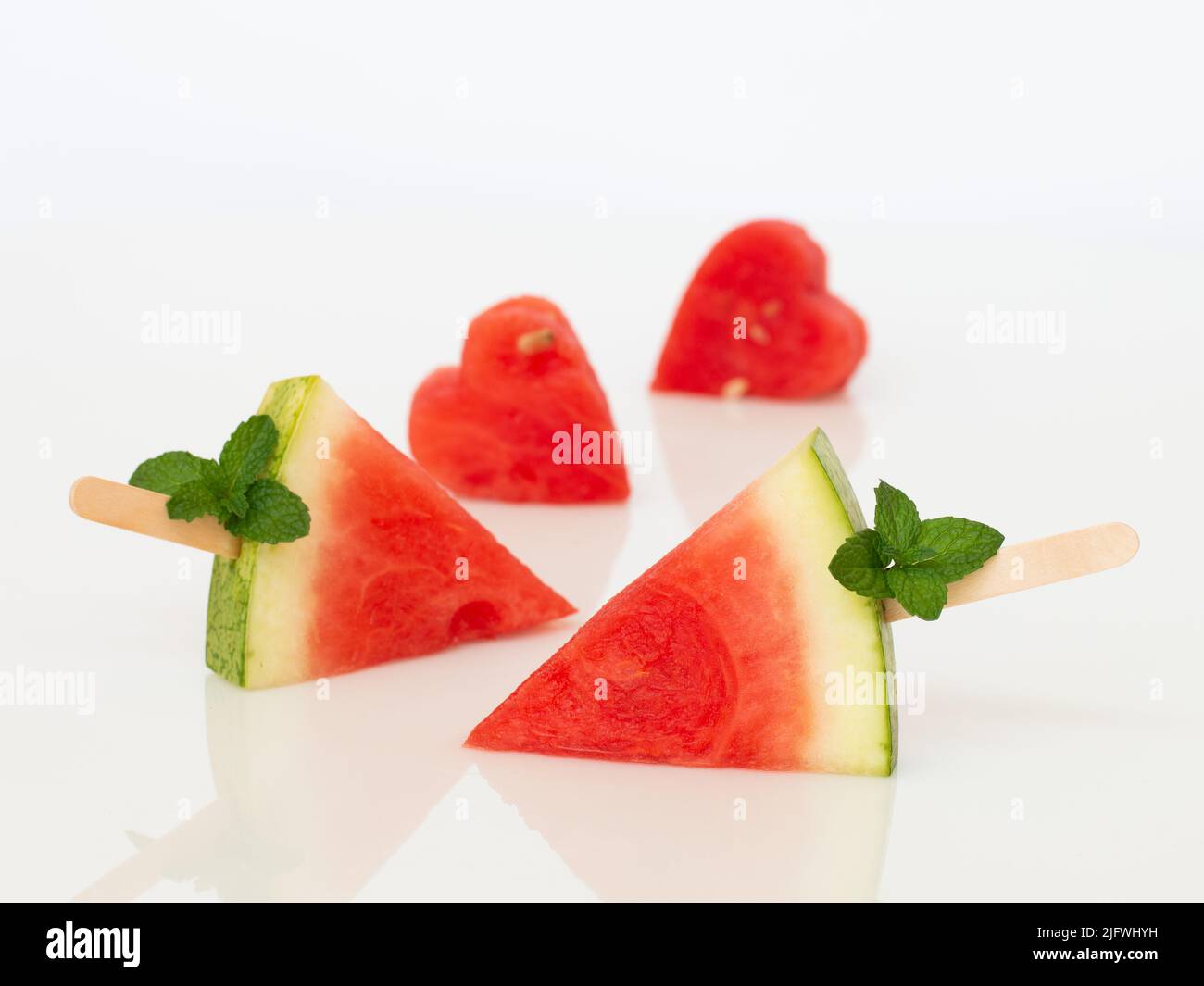 Close up of watermelon pop stick decorated with mint and have heart ...