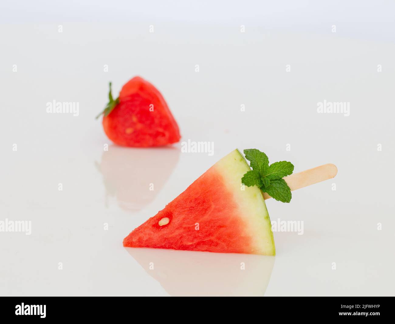 Close up of watermelon pop stick decorated with mint and have heart ...