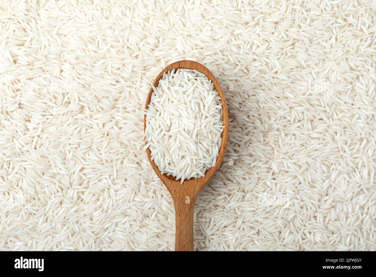 White rice on a wood spoon Stock Photo - Alamy