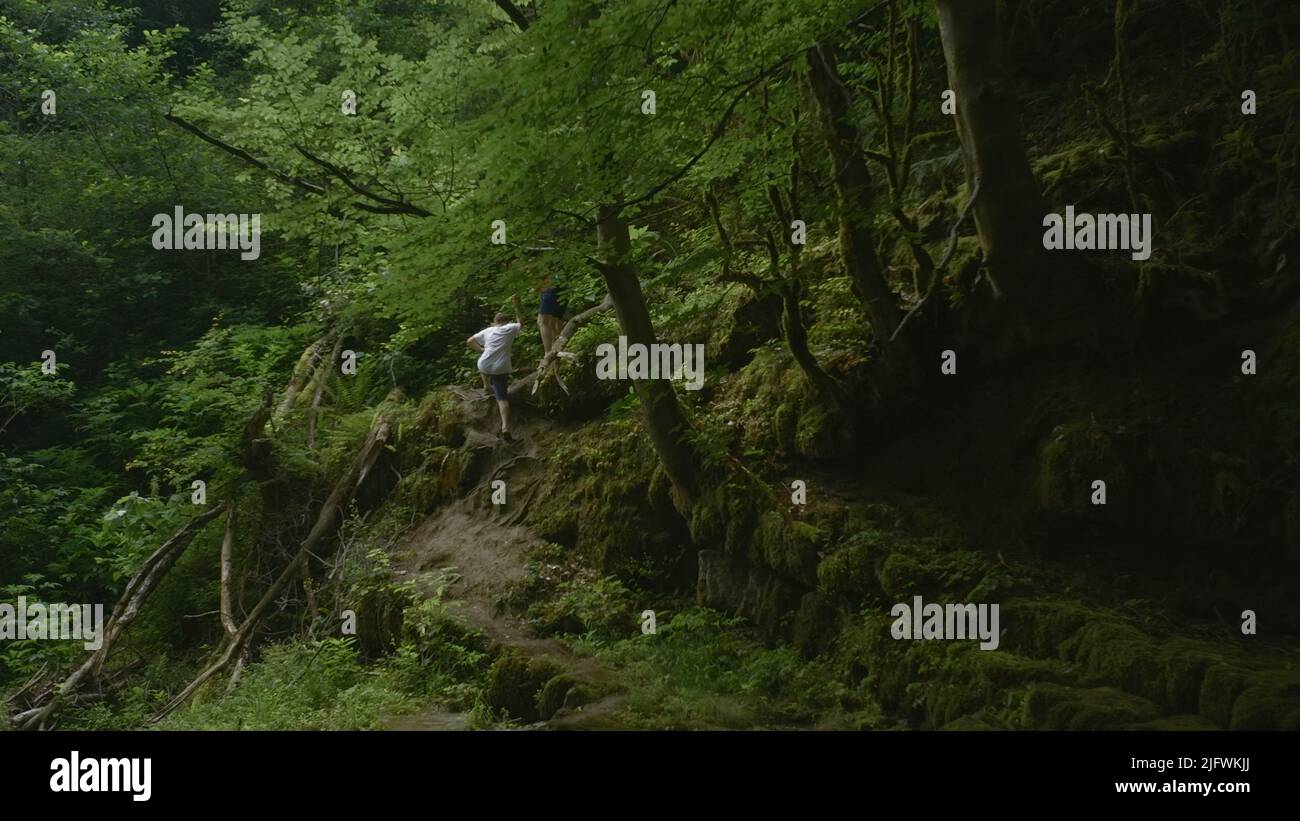 Hiking with hild in rocky jungle. Creative. Child and mother go hiking ...