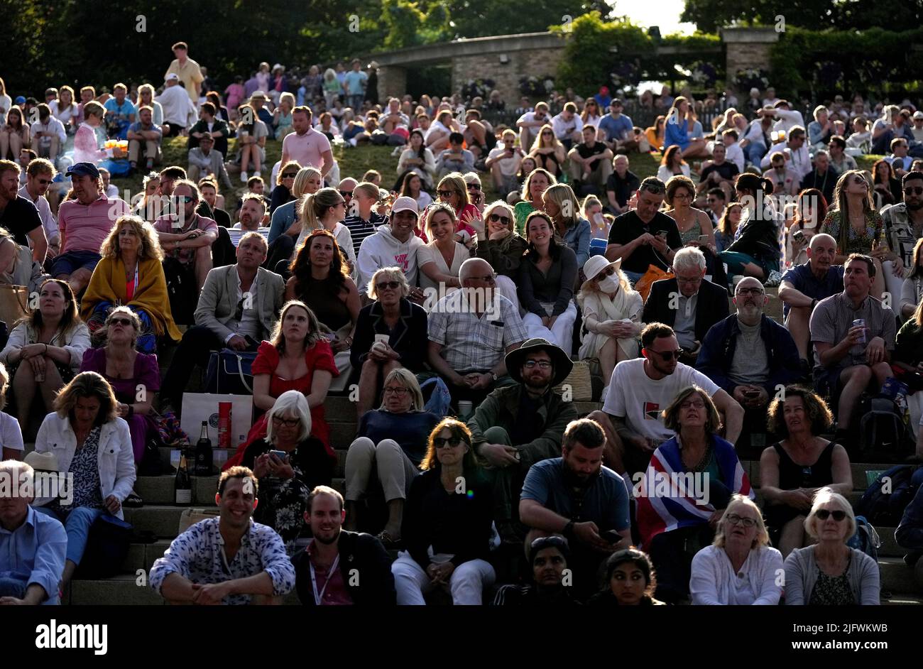 Spectators watch the action on the big screens on the hill outside ...