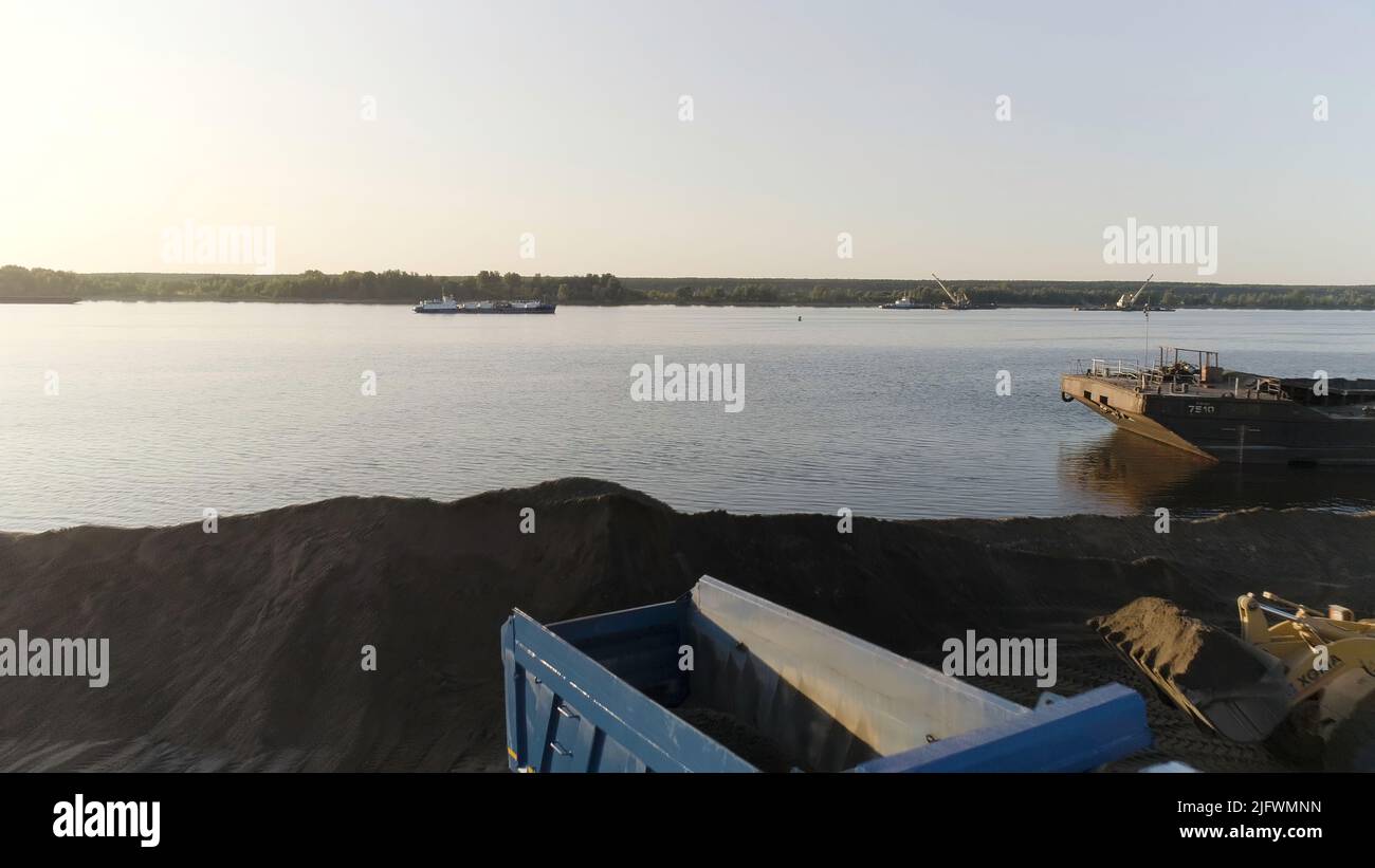 Clearing shoreline of river with ships. Scene. Top view of river with ...