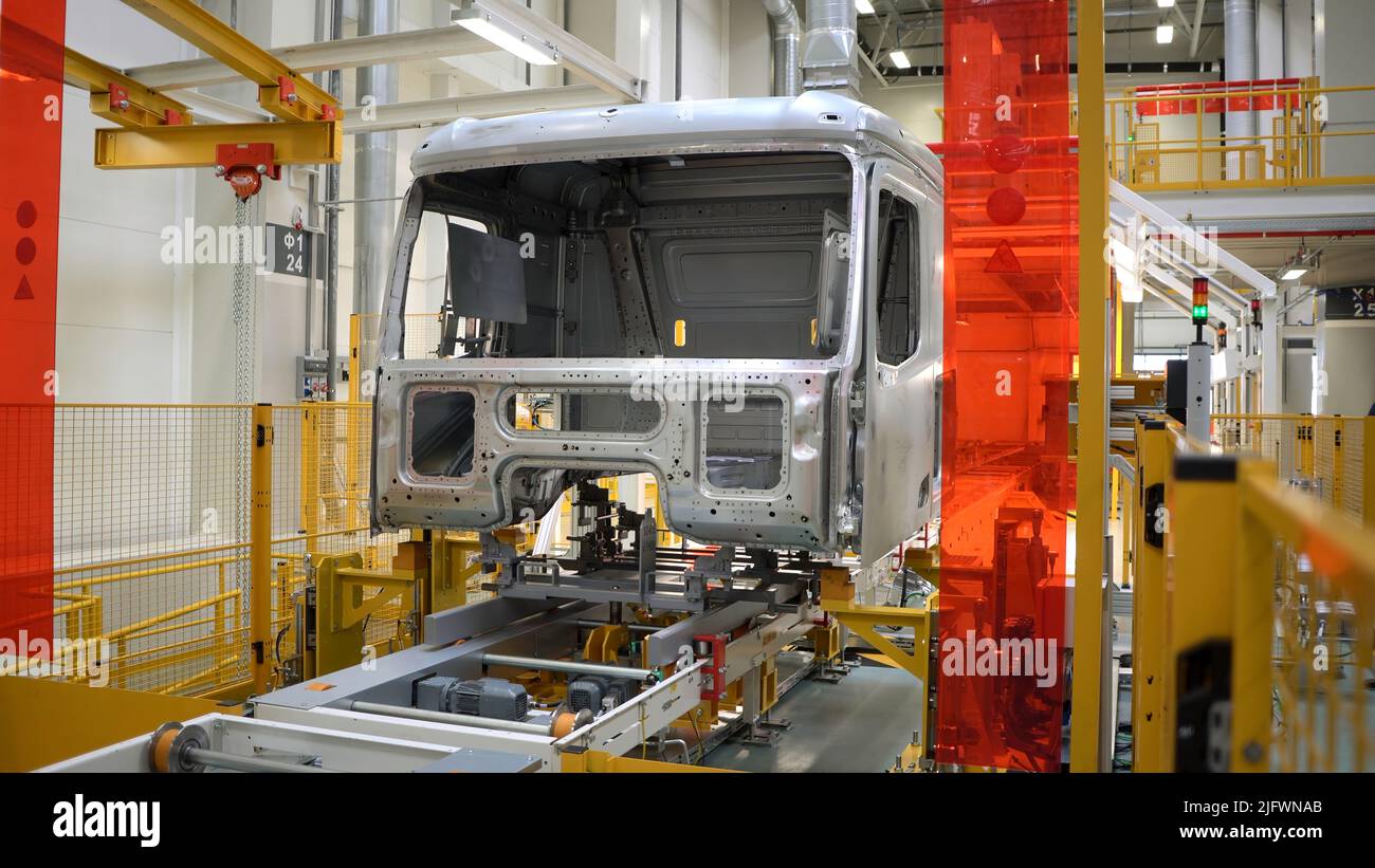 Truck body at factory. Scene. Frame of truck is moving on rails of ...