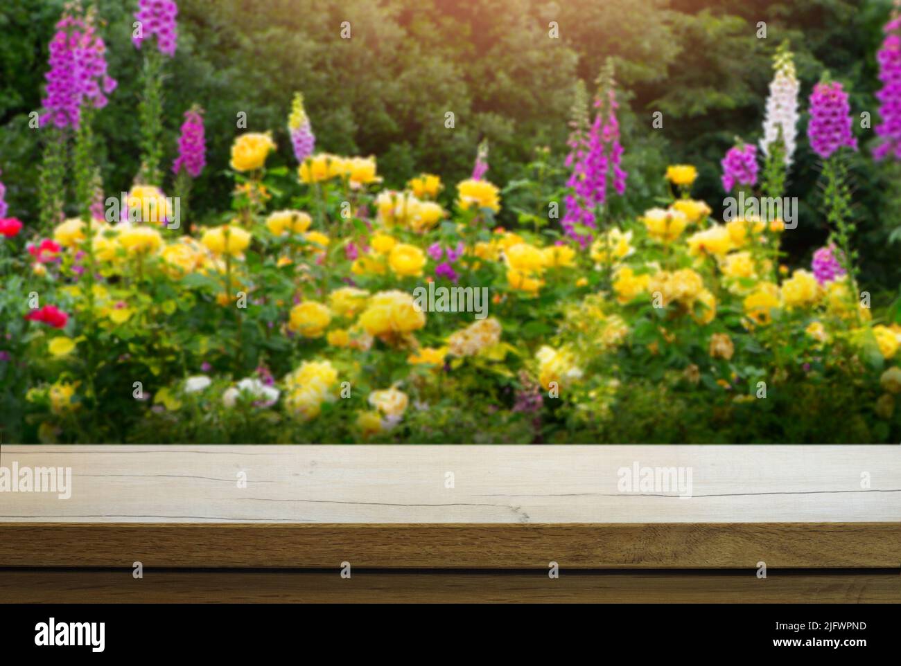 Empty wooden table on flowering garden background. Outdoor mockup for ...