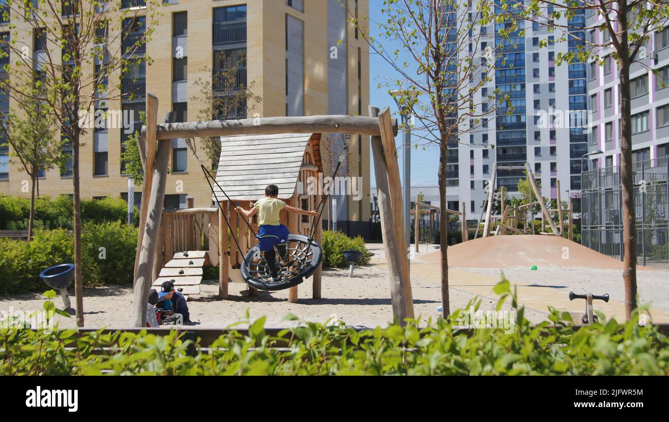 Modern playground with plants. Stock footage. Children play on modern ...