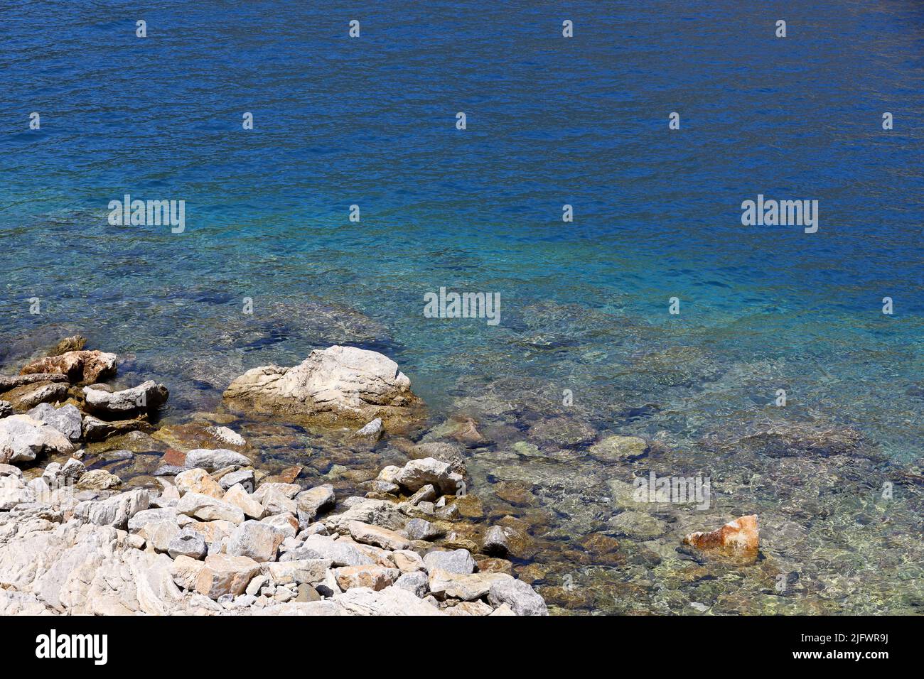 Aerial view to sea beach with stones on a bottom. Summer coast in sunny ...