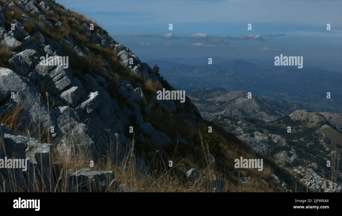 Beautiful landscape with rocky slope and panorama of mountains ...