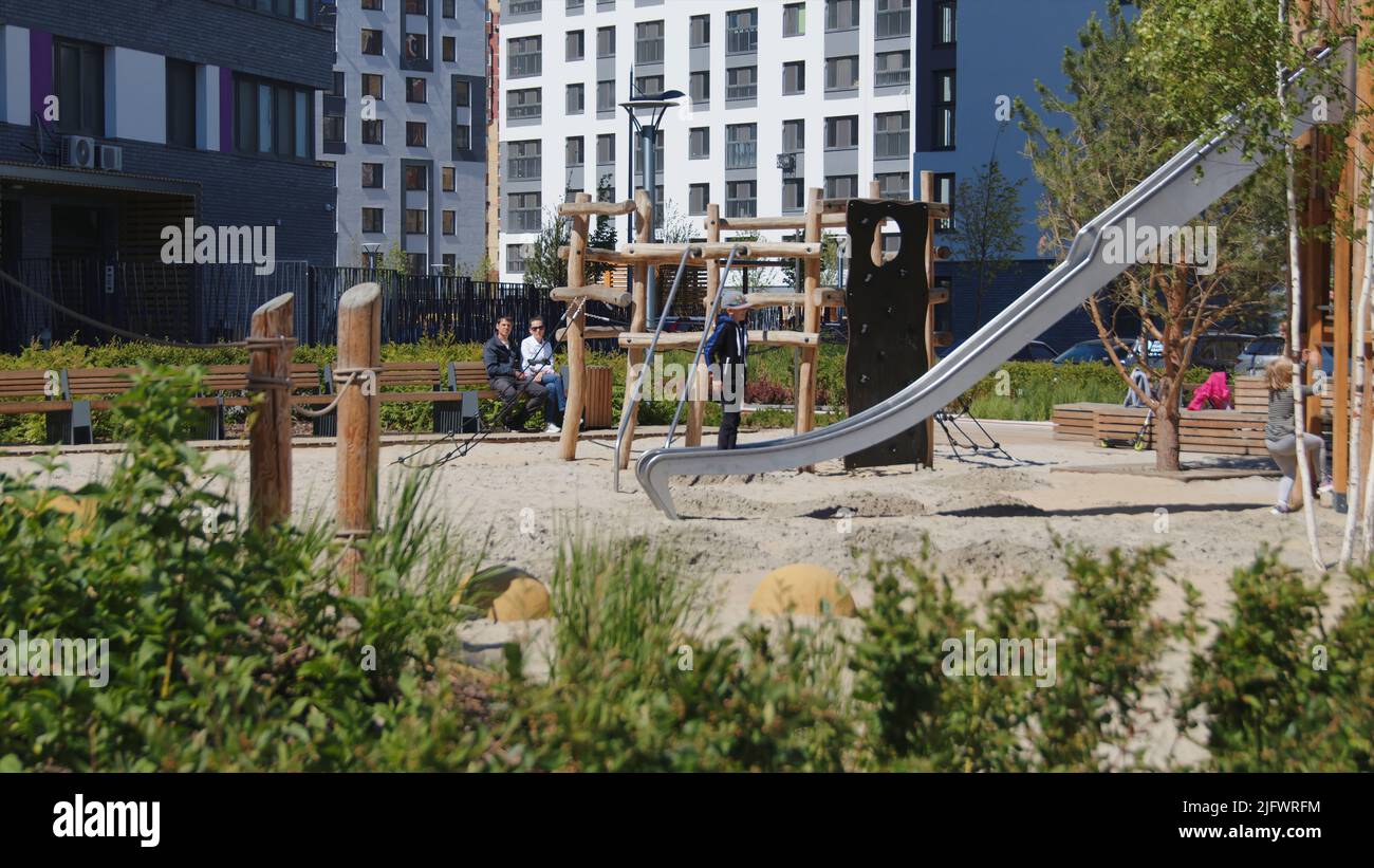 Modern playground with plants. Stock footage. Children play on modern ...