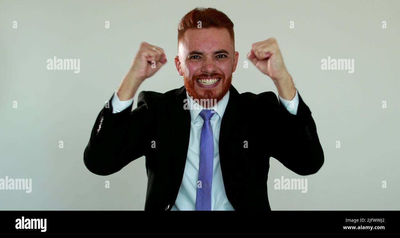 Happy executive raising fists in celebration, business manager ...