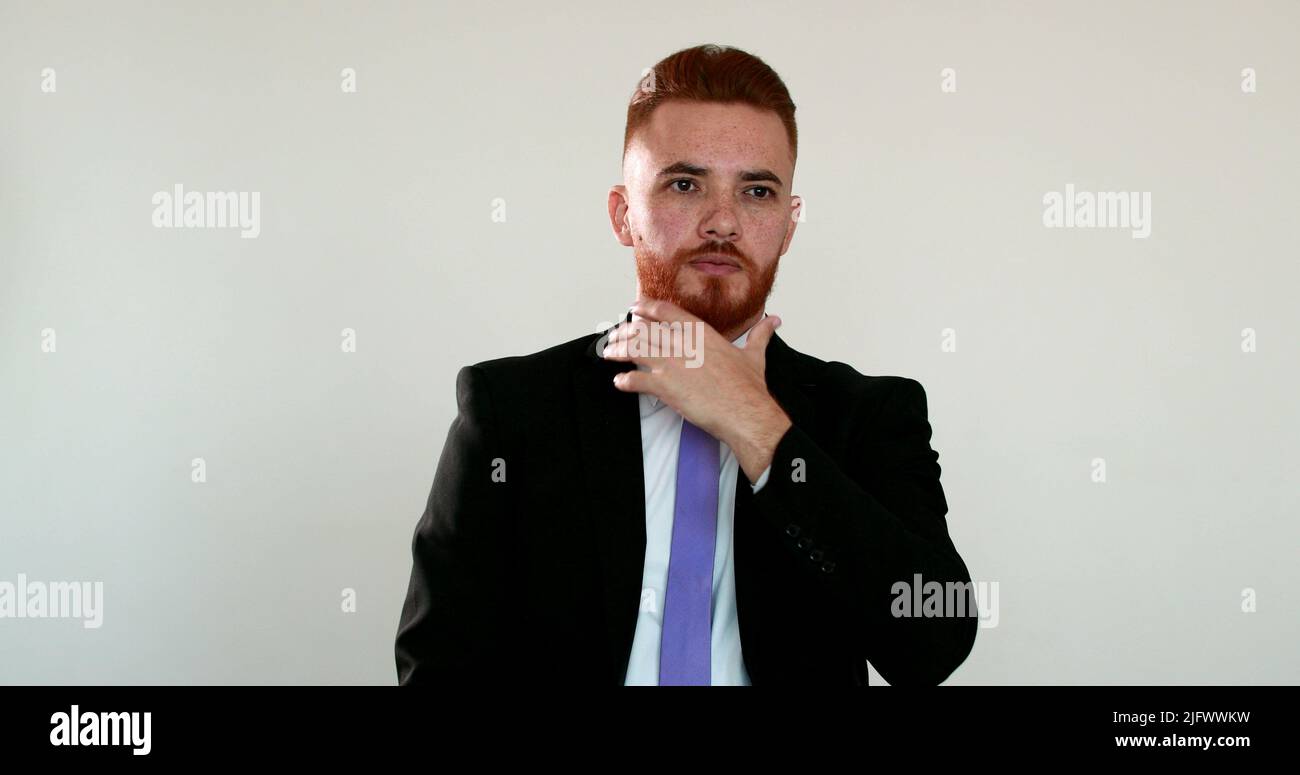 Irish looking executive manager touching beard thinking, redhair man ...