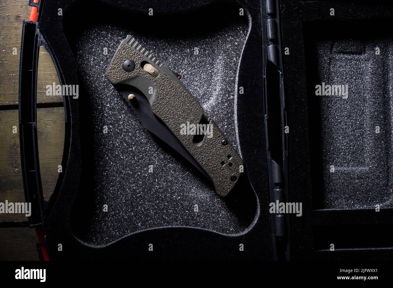 Folding army knife in a black box. Knife with olive handle. Pocket ...