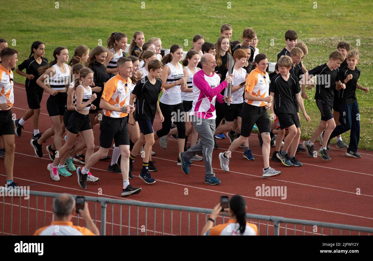 Cheltenham, UK. 05th July, 2022. A Baton Bearer runs with The Queen's ...