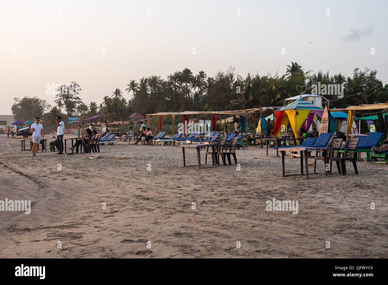 Mandrem Beach, Goa India May27 2022: Tourists and families relaxing and ...