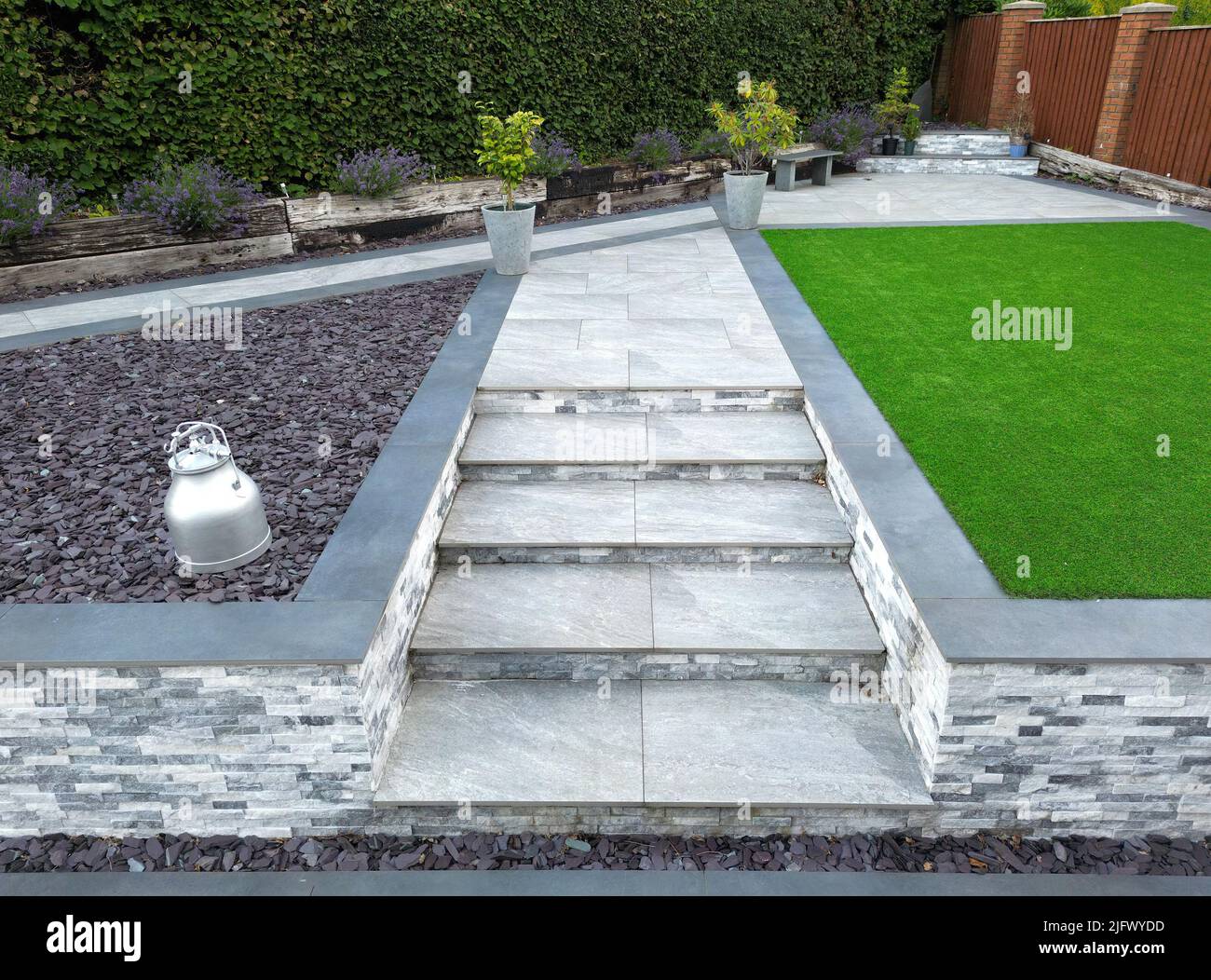 Elevated view of landscaped garden with contrasting light and dark grey ...