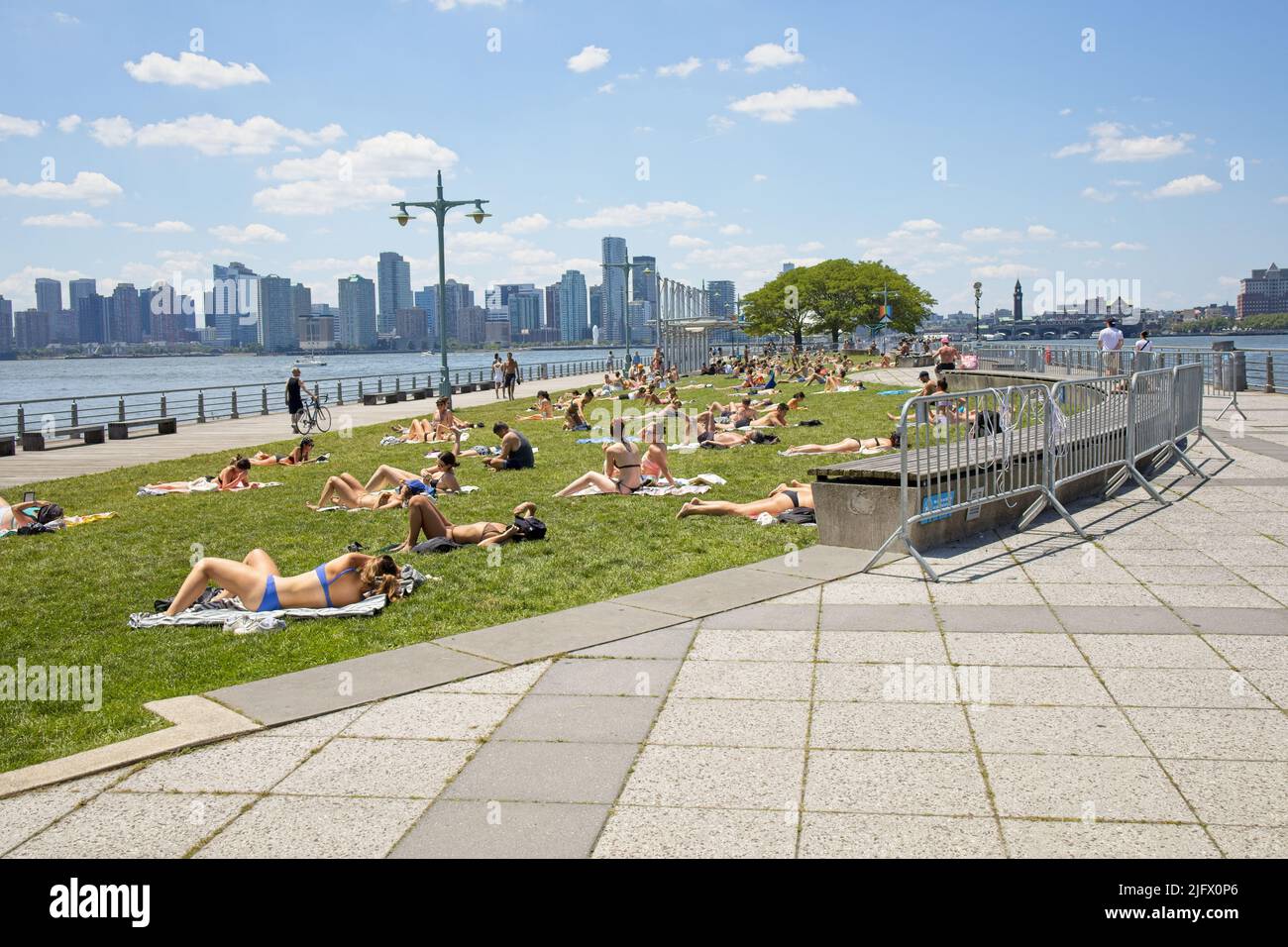 New York, NY, USA - June 26, 2022: Sunbathing on a NYC pier on Hudson ...