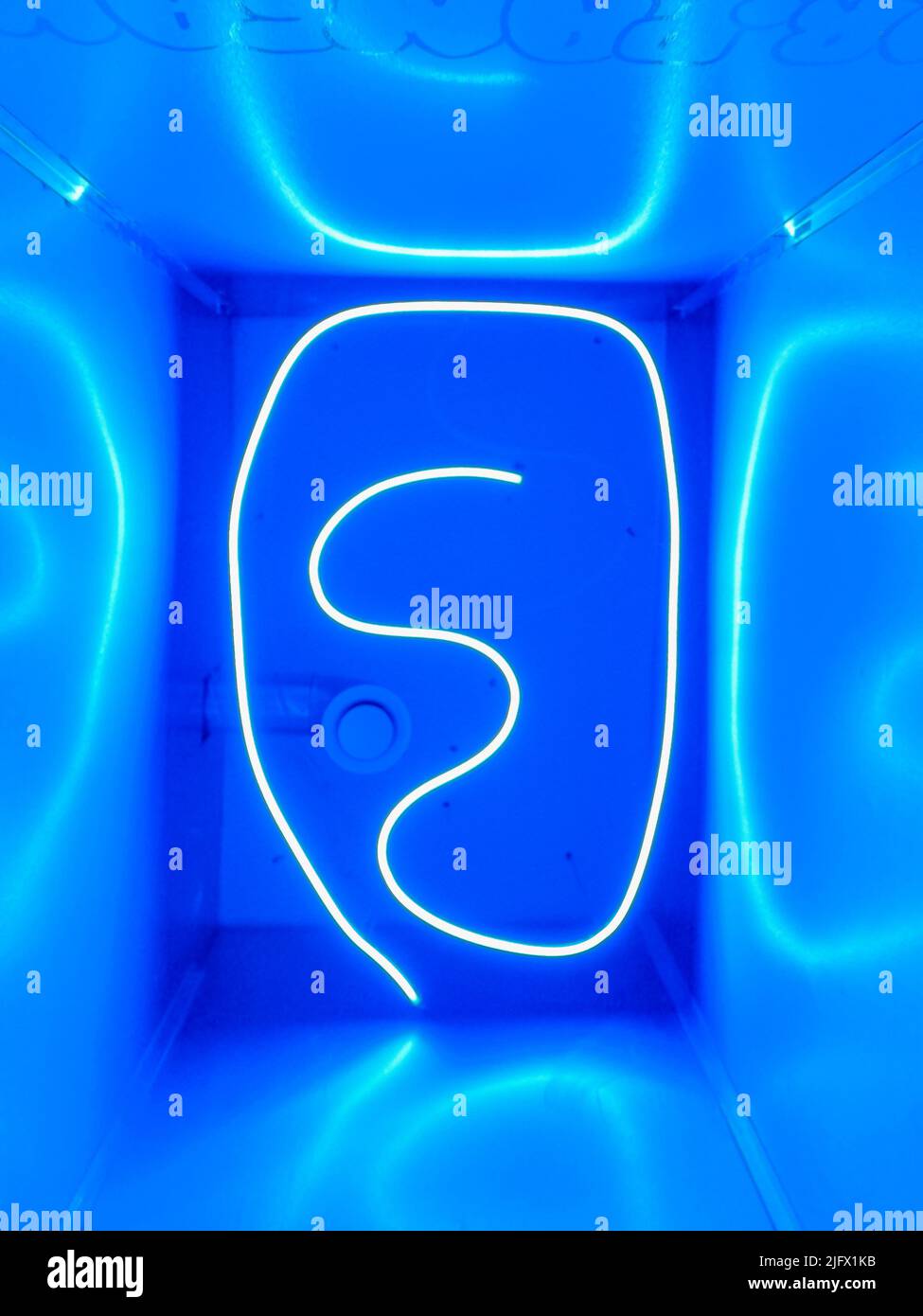 Beautiful glowing blue neon light at ceiling of toilet cubicle with ...