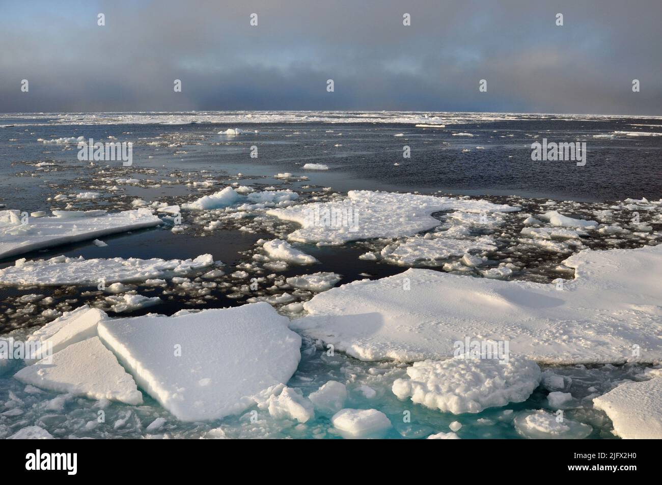 Blue sky begins to break through the clouds over Arctic Ocean ice, View ...