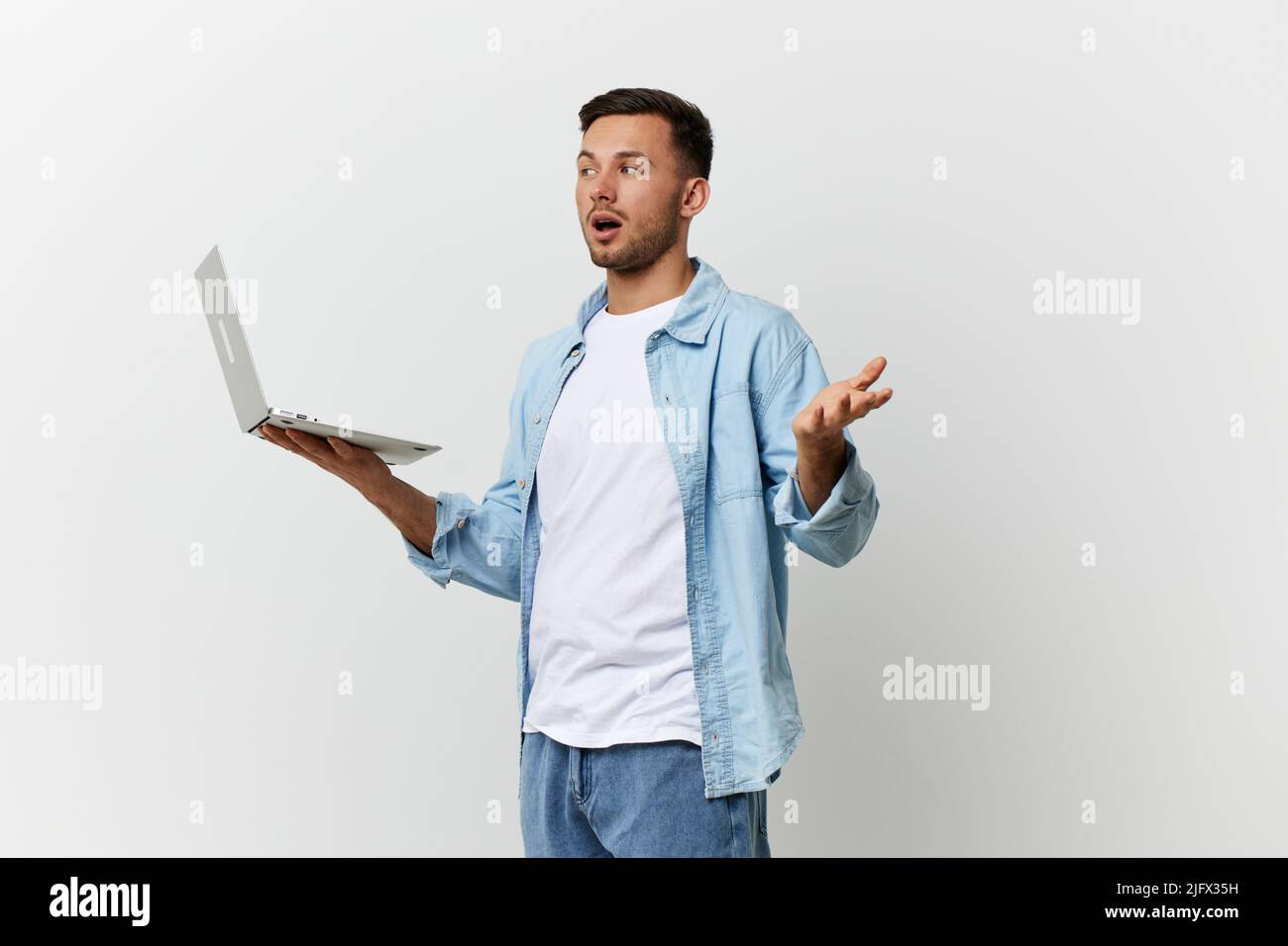 Shocked unhappy tanned handsome man in casual basic t-shirt irritated ...