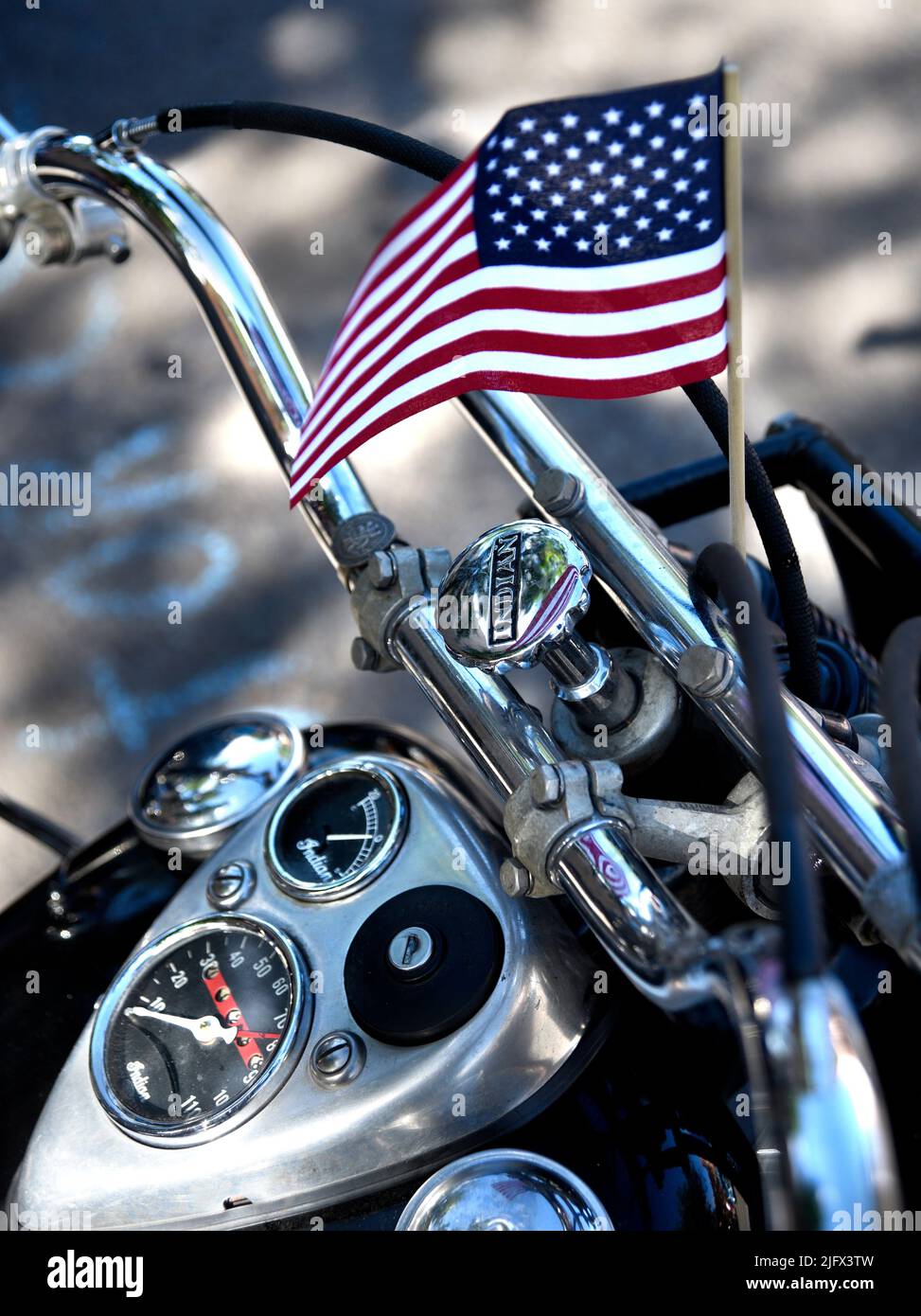A small American flag flies on a vintage Indian motorcycle on display ...