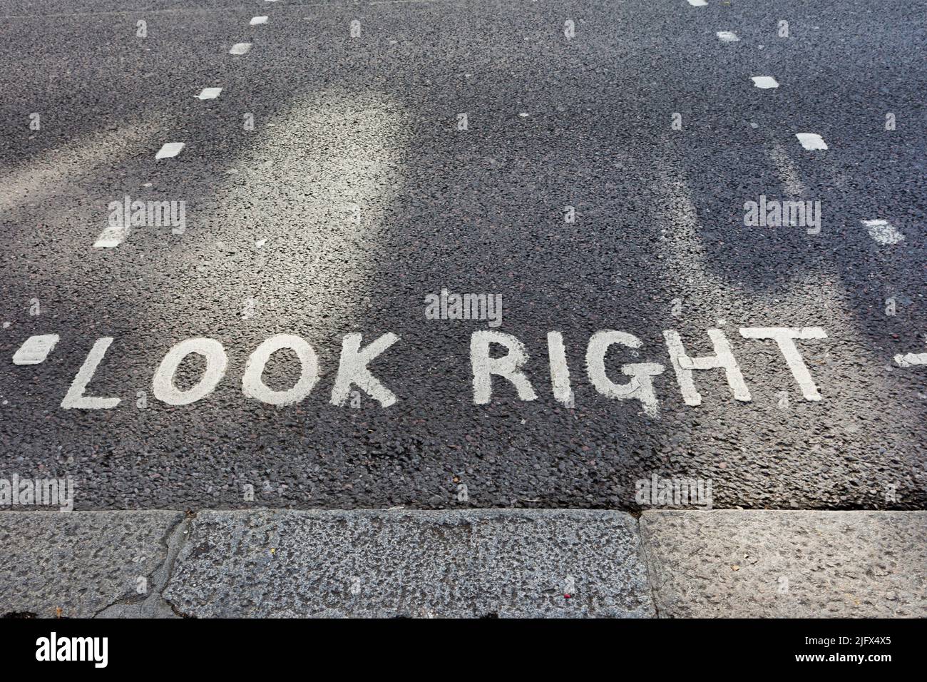 "Look Right", sign on road edge advising safety for pedestrians. London ...