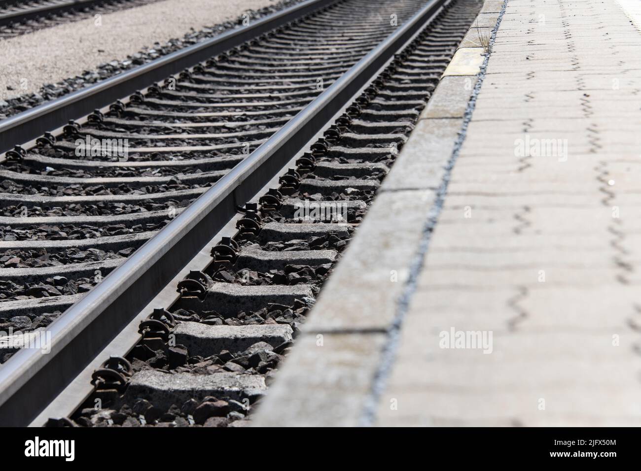 Ground view of railroad tracks running diagonally through the image ...