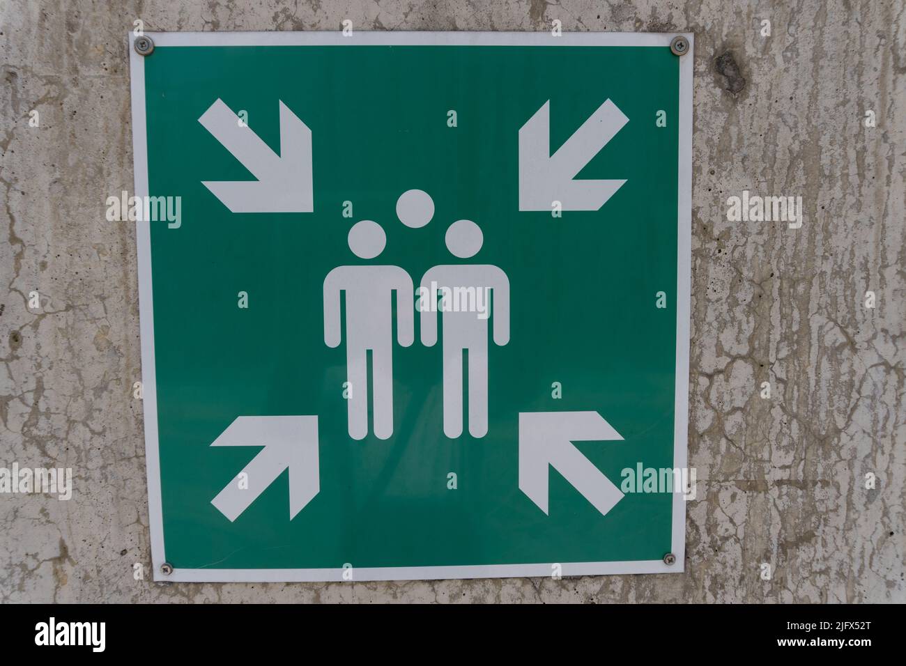 Close up of green sign pointing to a gathering meeting place point ...