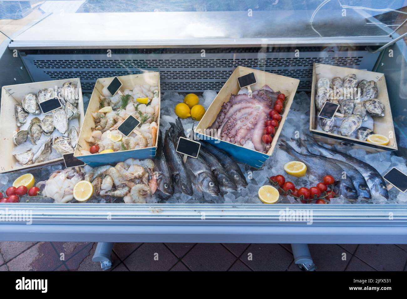 Close up of a fish market stall at a weekly market with various seafood ...
