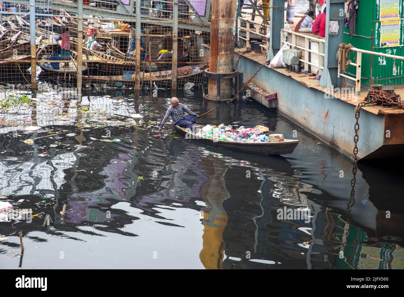 A man collects plastic waste form Buriganga River, Dhaka, Bangladesh ...