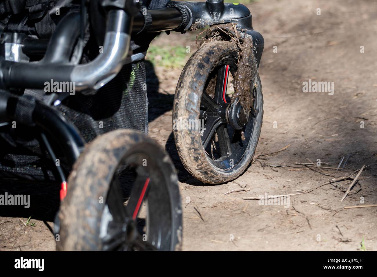 mud-stained baby stroller strolling through the wet countryside Stock ...