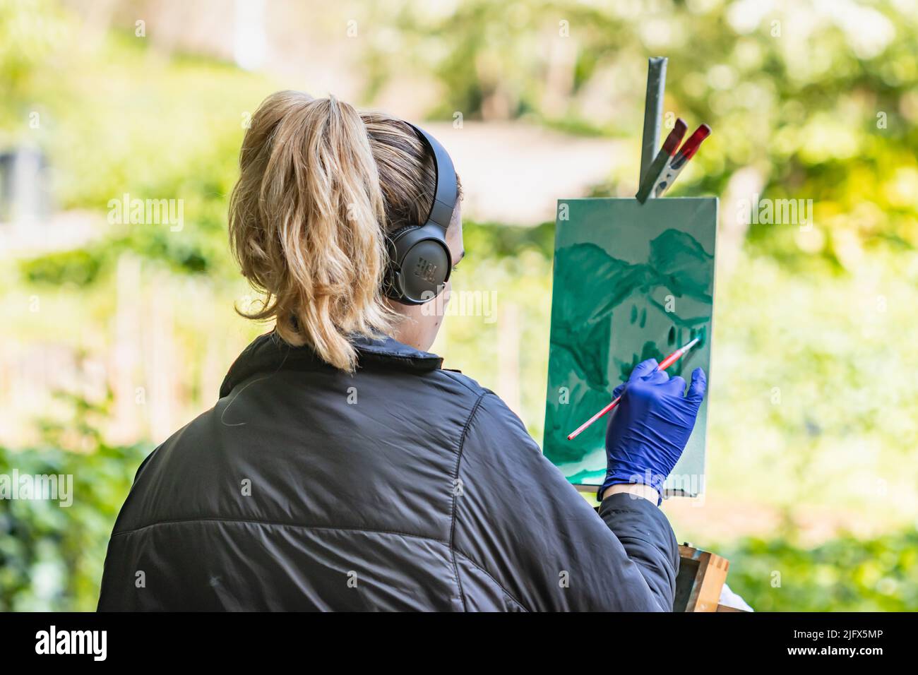 Barcelona, Spain - April 22, 2022: female artist painting a picture in ...