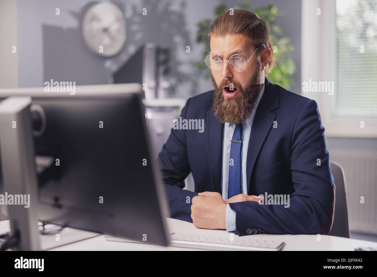 Shocked businessman at office Stock Photo - Alamy