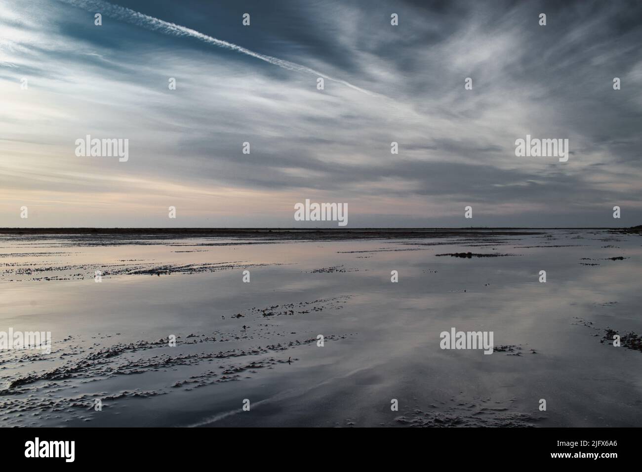 A scenic view of the beach on a cloudy day in Bembridge, Isle of Wight ...