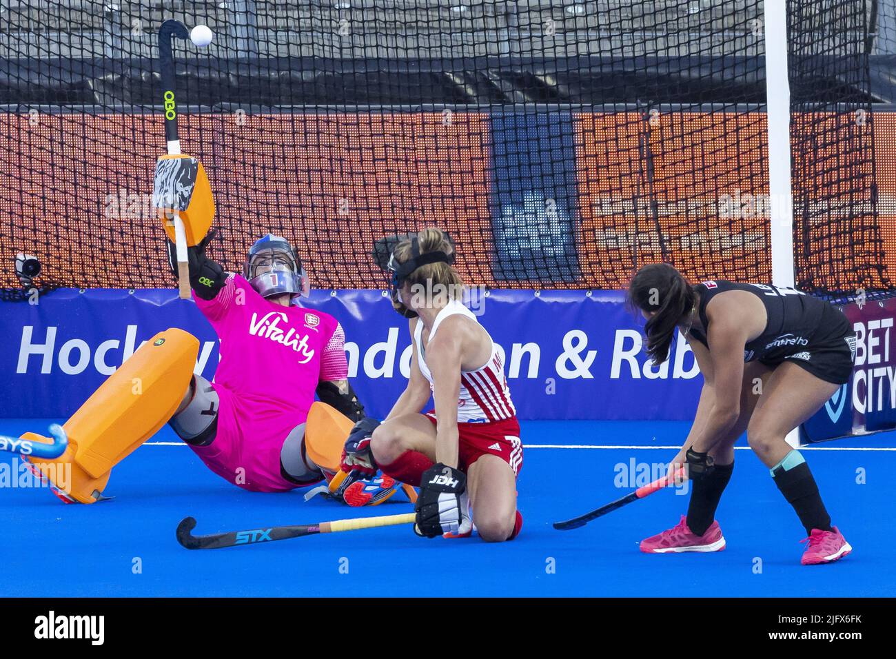 AMSTERDAM - Tyler Lench (NZL) knocks the ball over goalkeeper Maddie ...