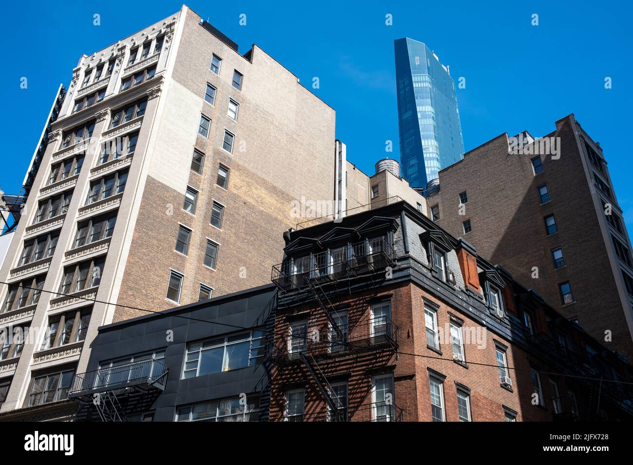 mix of classic stone and brick building facades and modern skyscraper ...