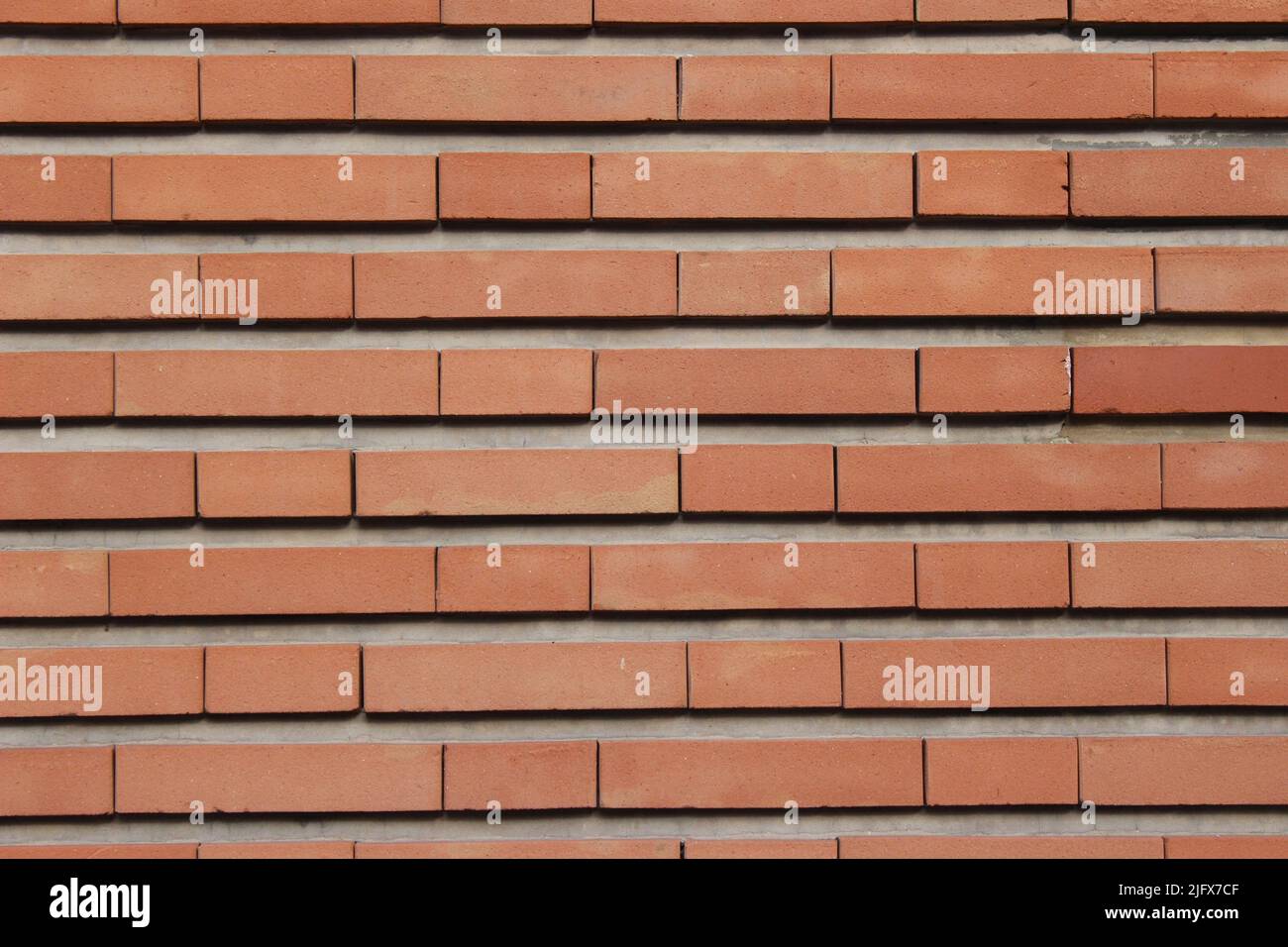 red brick wall seen from the outside with all its bricks aligned one on ...