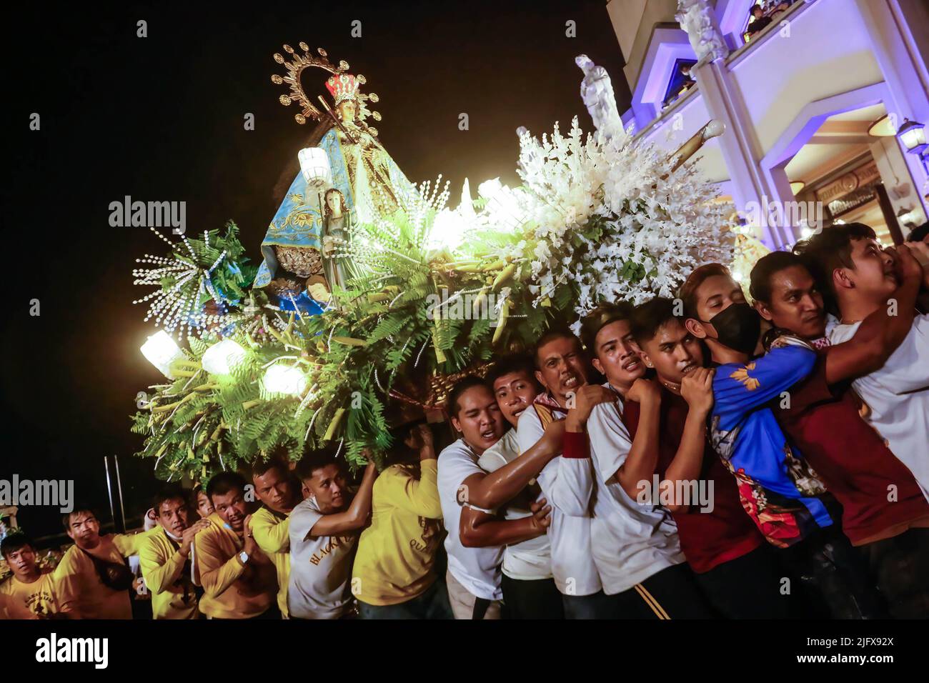 Devotees carry the carriage of Blessed Virgin Mary during the solemn ...