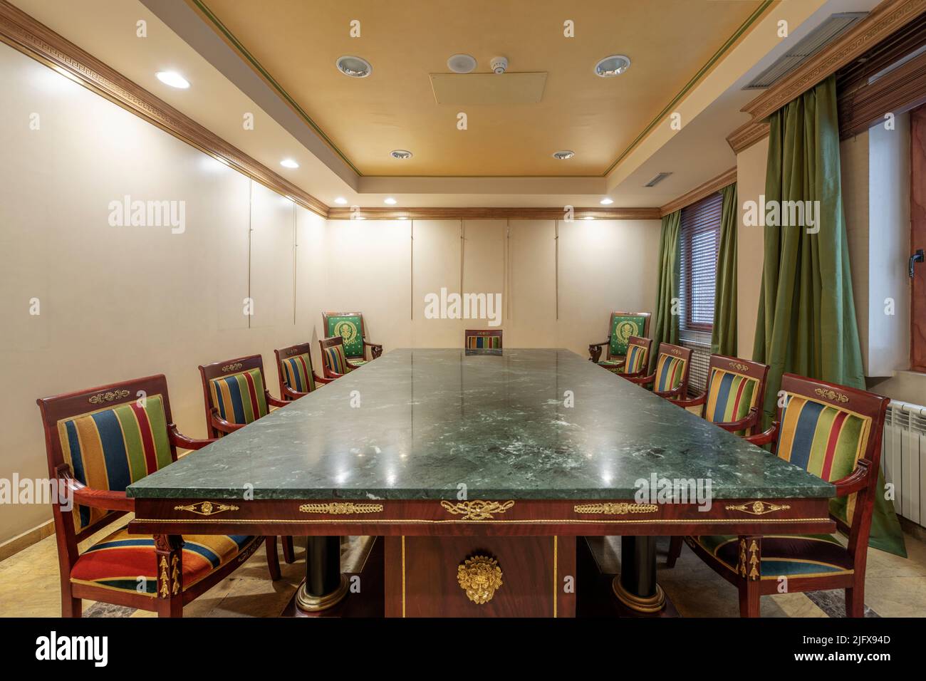 Meeting room with a wooden table and green marble with chairs ...
