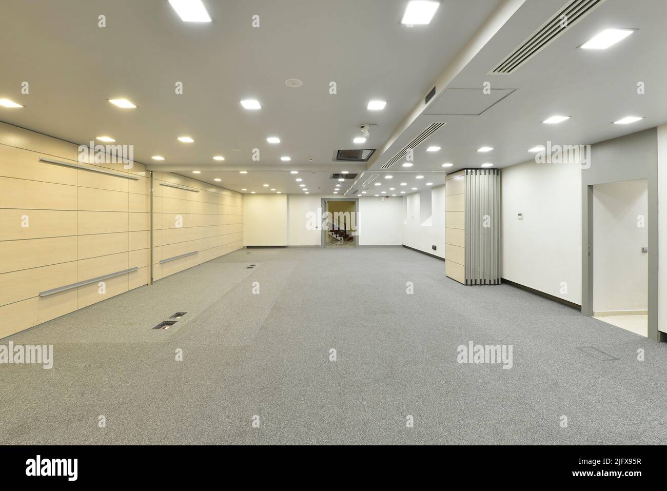 Large room to dedicate to empty offices, with floors covered with gray ...