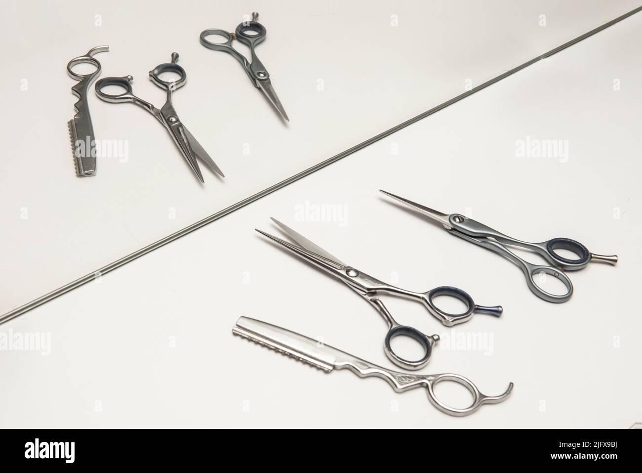 Sharp and clean scissors ready for haircuts in front of a mirror Stock ...