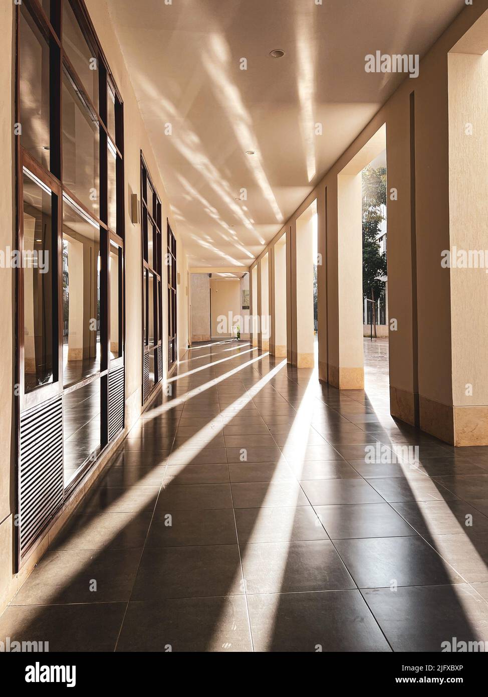 A corridor of a modern building with reflective windows Stock Photo - Alamy