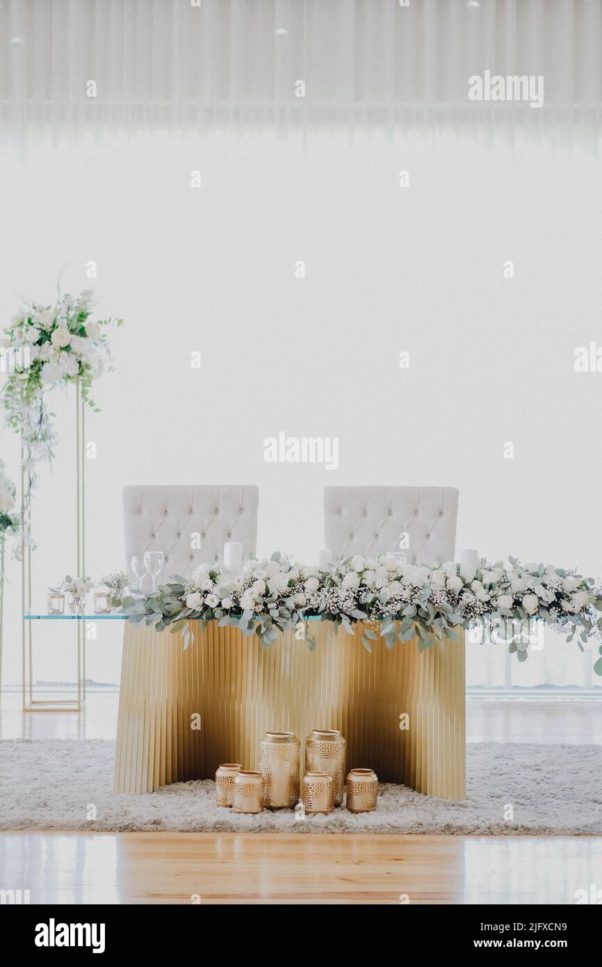 A vertical shot of the seats of the bride and the groom at a reception ...