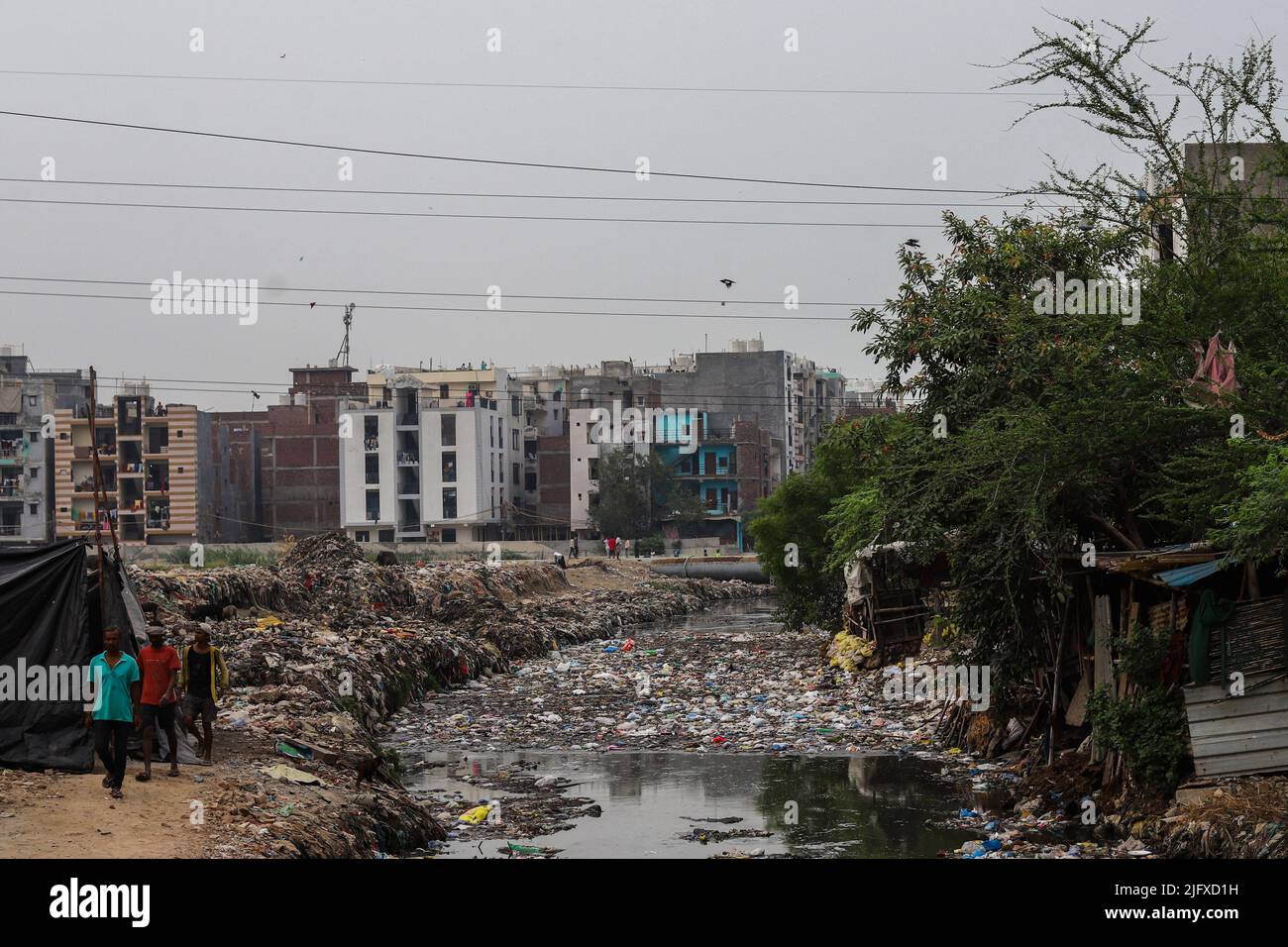 View of an open dump area filled with plastic and garbage at a slum ...