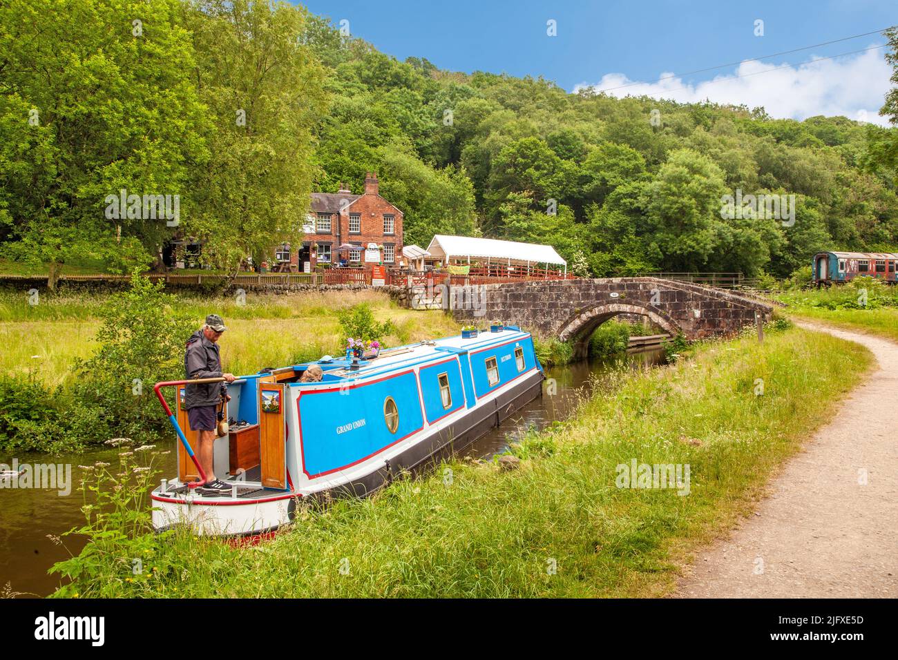 Canal narrowboat moored on the Caldon canal outside the Black Lion pub ...